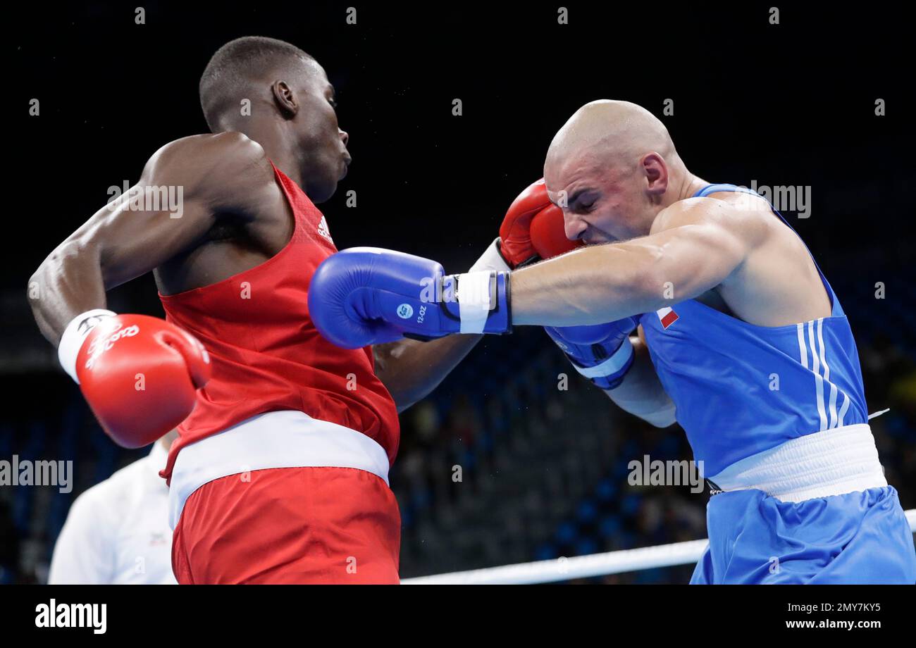 Poland's Igor Pawel Jakubowski, right, fights Britain's Lawrence Okolie ...
