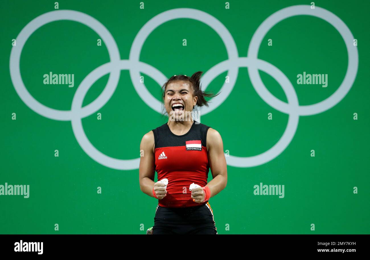 Sri Wahyuni Agustiani, of Indonesia, celebrates after a successful lift ...