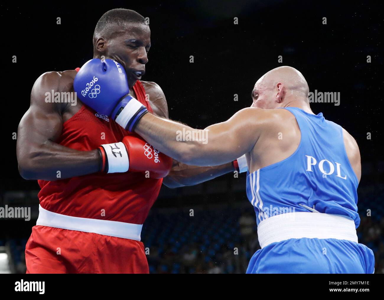 Poland's Igor Pawel Jakubowski, right, fights Britain's Lawrence Okolie ...