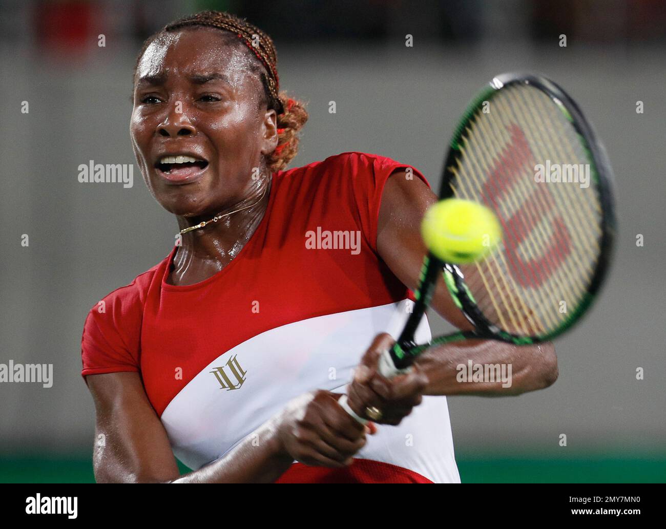 Venus Williams of the United States returns a ball to Belgium's Kirsten ...