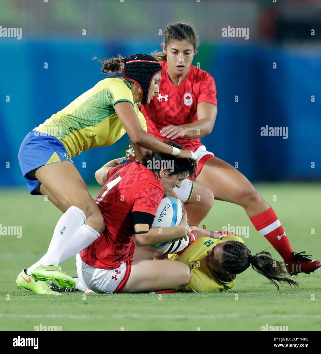 Canada's Brittany Benn, bottom left, is tackled Brazil's Raquel ...