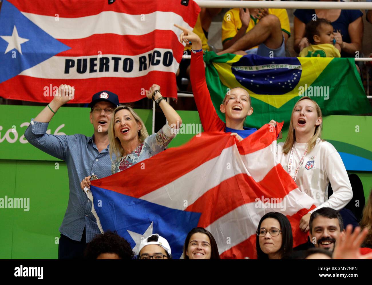 Fans cheer on Puerto Rico during a women's preliminary volleyball match ...