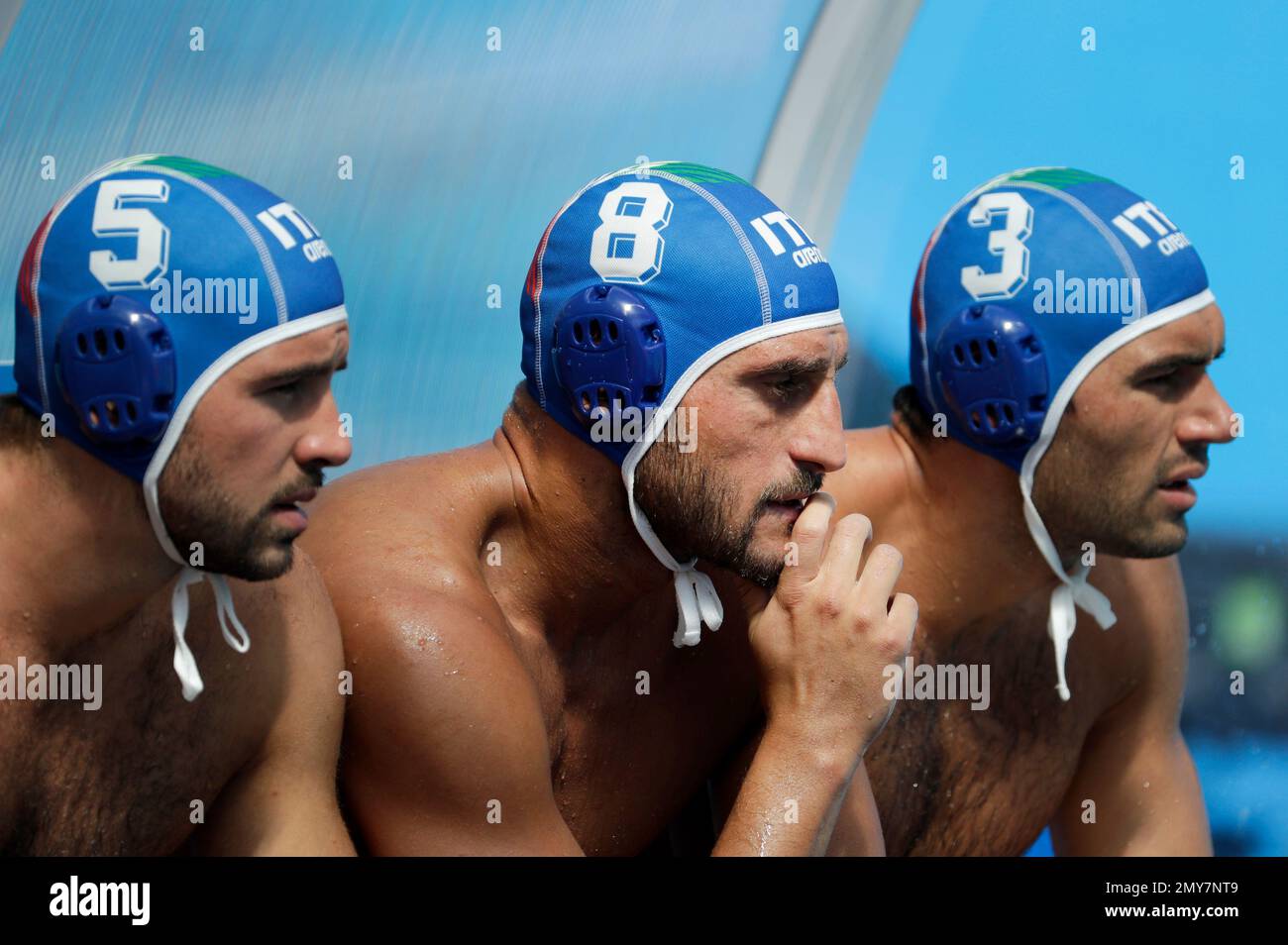Alessandro Nora, center, of Italy gestures as he sits on the bench with ...