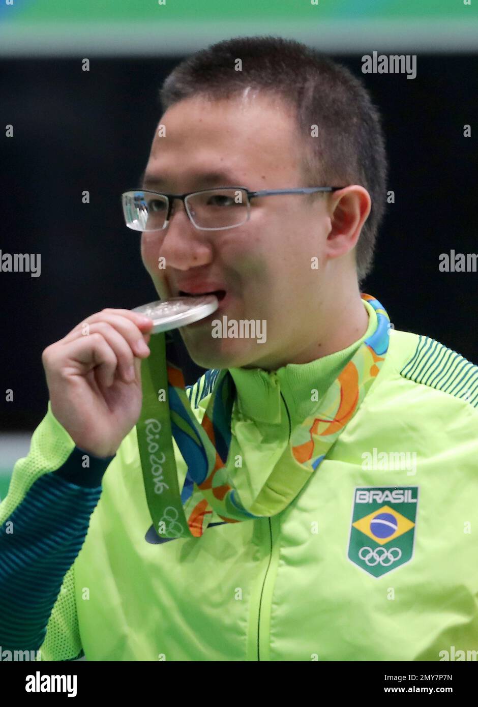 Felipe Wu of Brazil bites his silver medal during the award ceremony of ...
