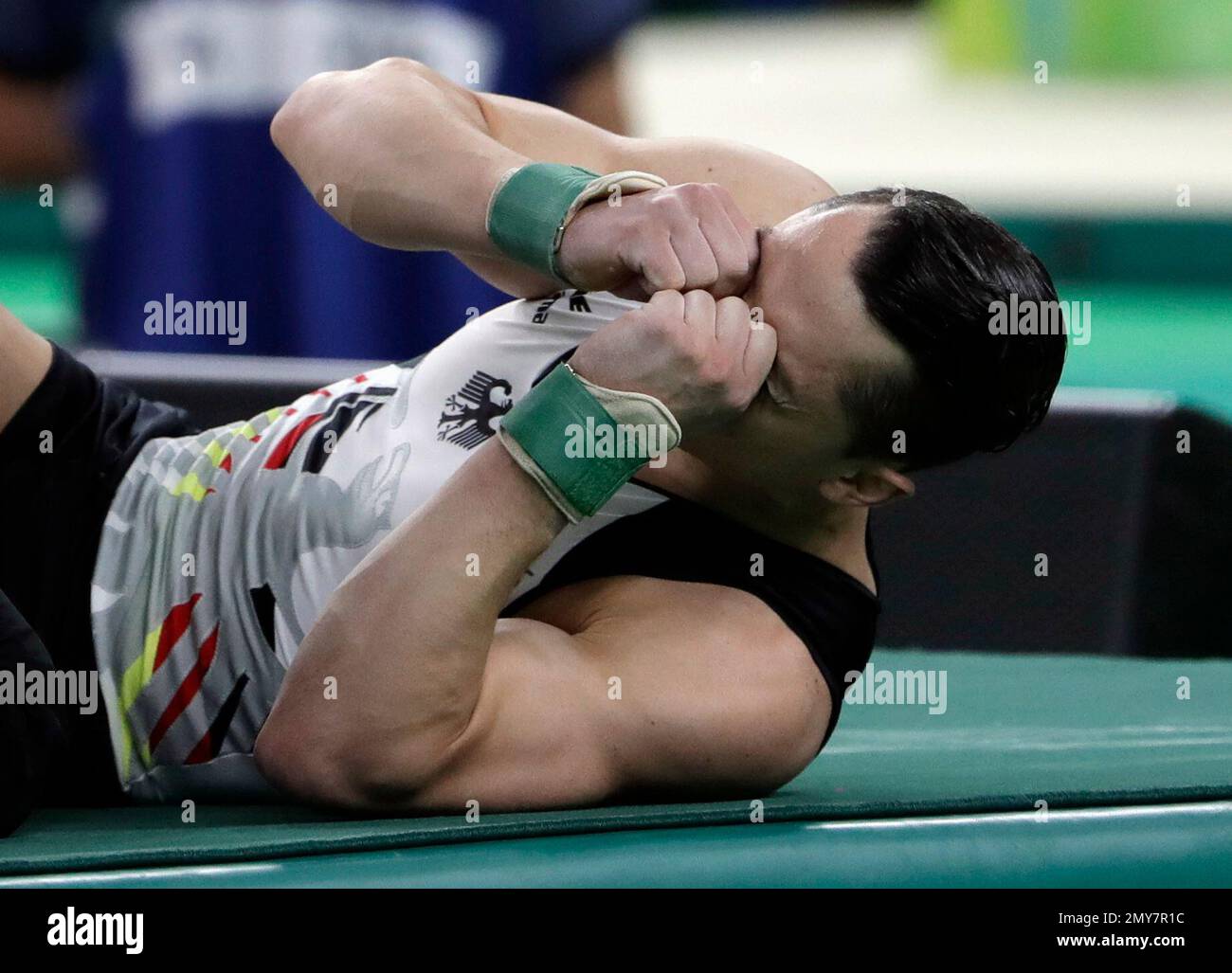 Germany's Andreas Toba reacts after falling while performing his floor ...