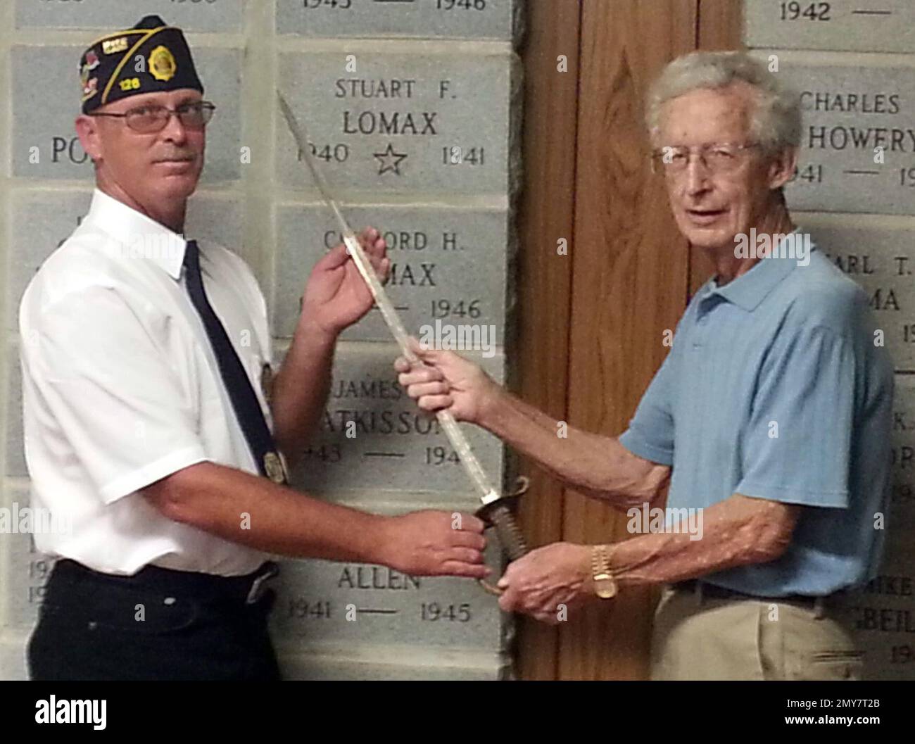 CORRECTS CREDIT AND SOURCE - Tom Hill, right, presents a sword to Gene ...
