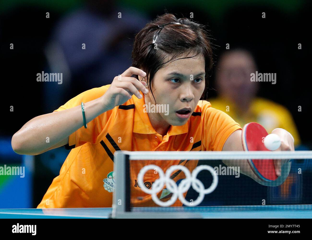 Ian Lariba of the Philippines returns a shot to Xing Han of the Congo ...