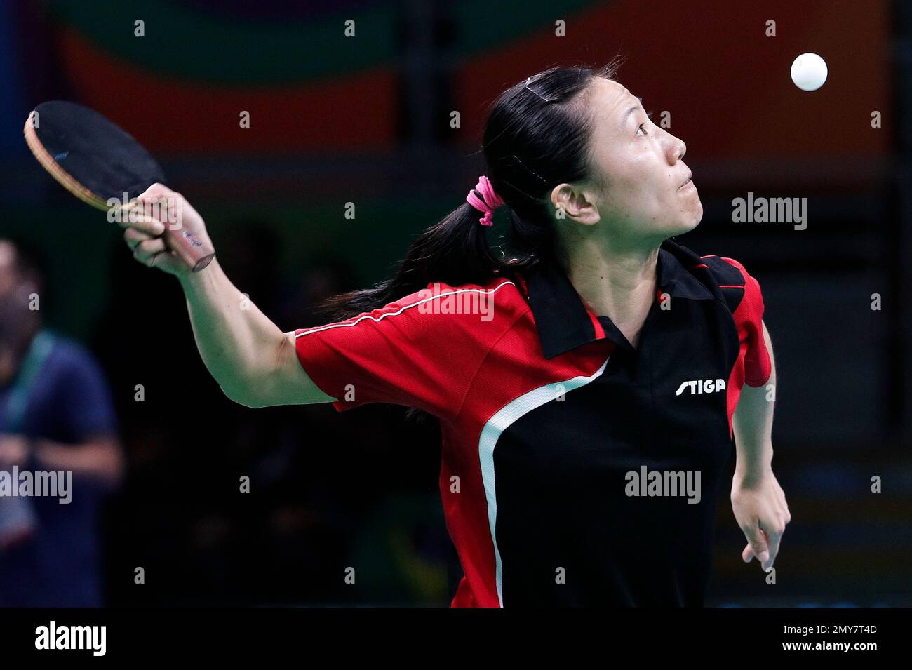 Xing Han of the Congo serves to Ian Lariba of the Philippines during ...