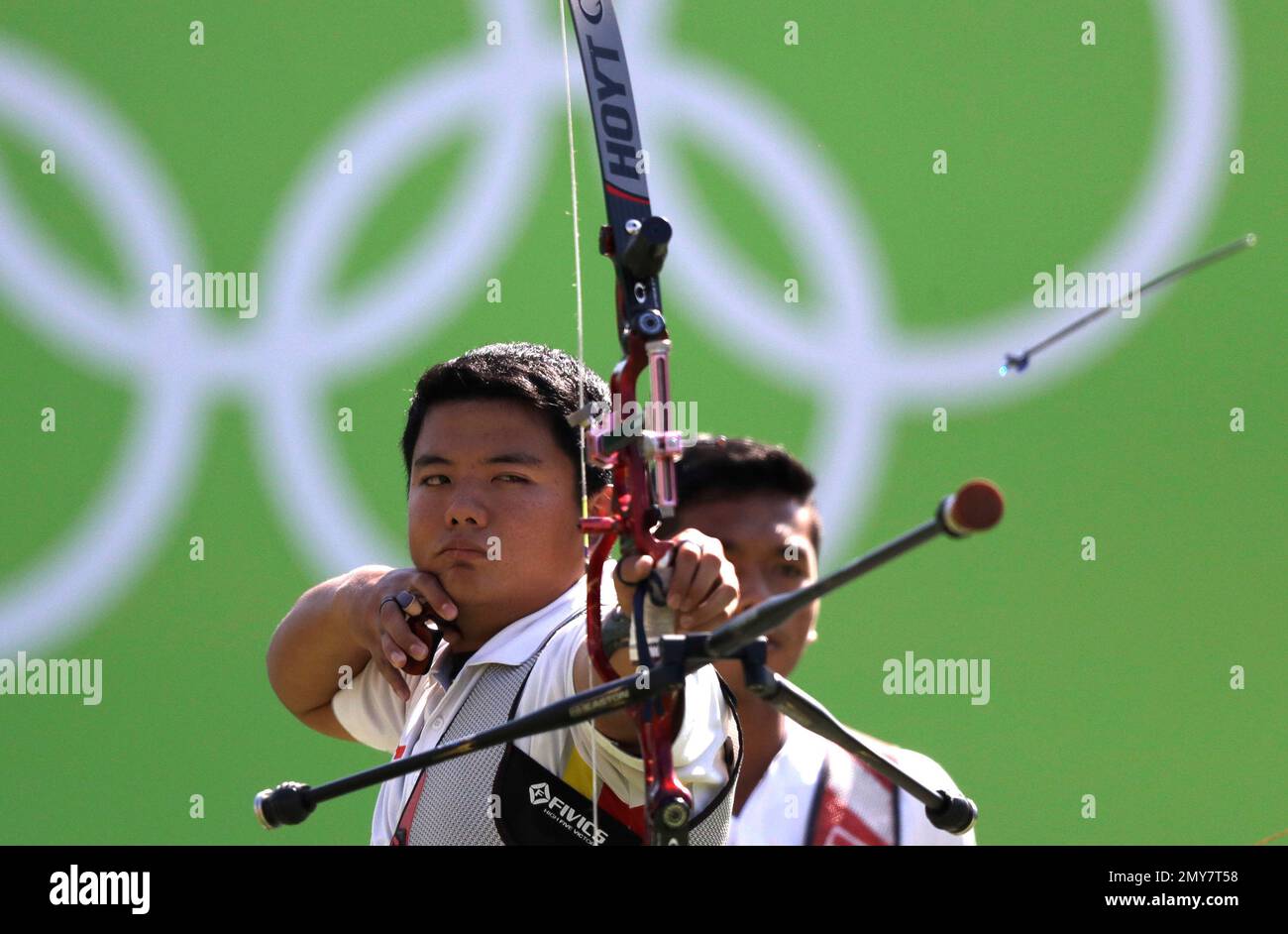 Indonesia's Muhammad Wijaya releases his arrow during the men's team ...