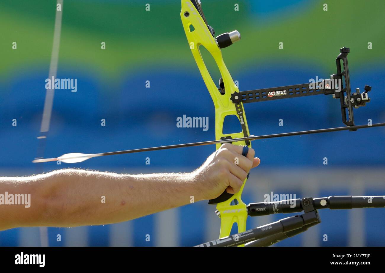 Lucas Daniel, of France, released the arrow during the men's team archery competition at the ...