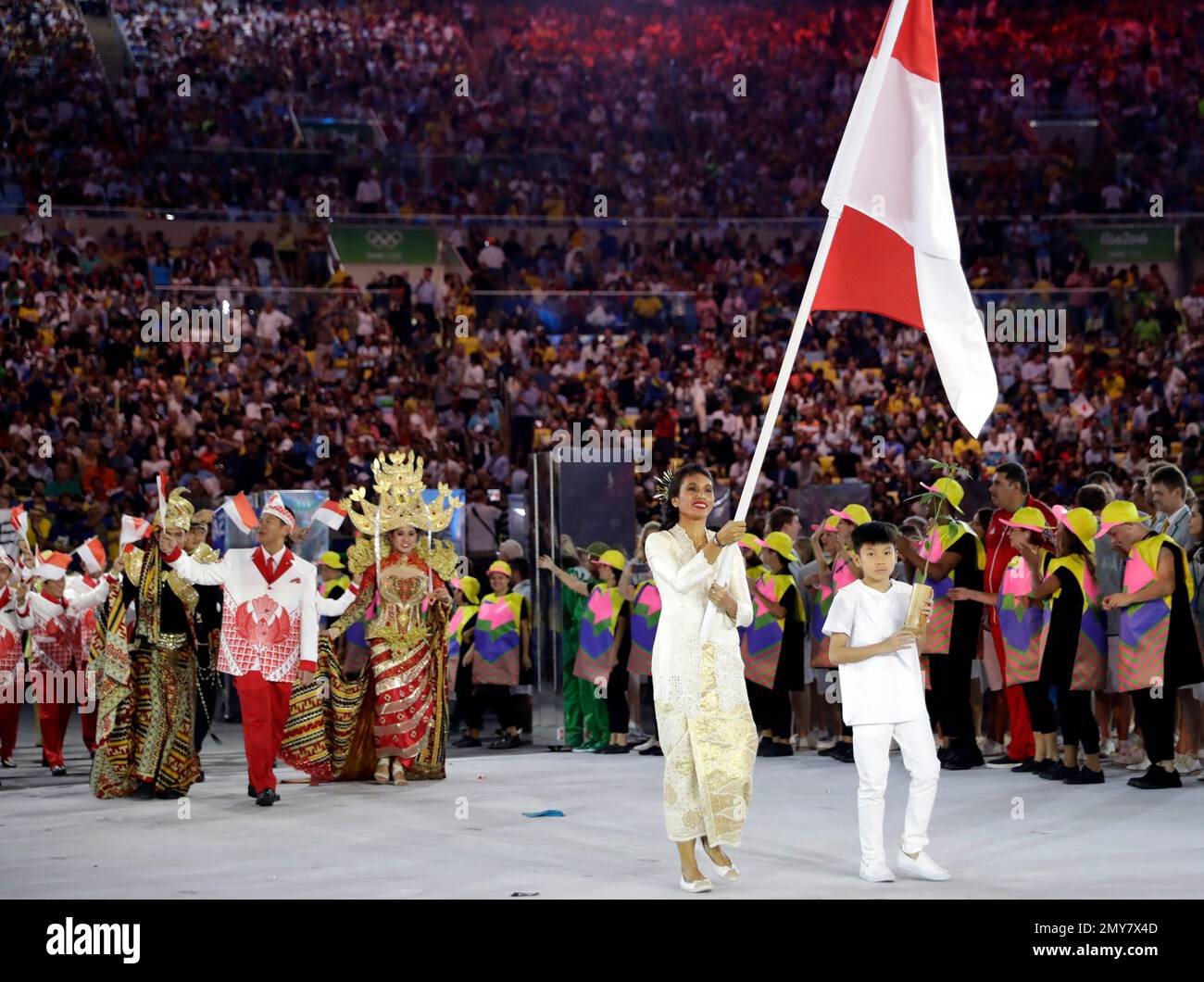 Maria Londa carries the flag of Indonesia during the opening ceremony ...
