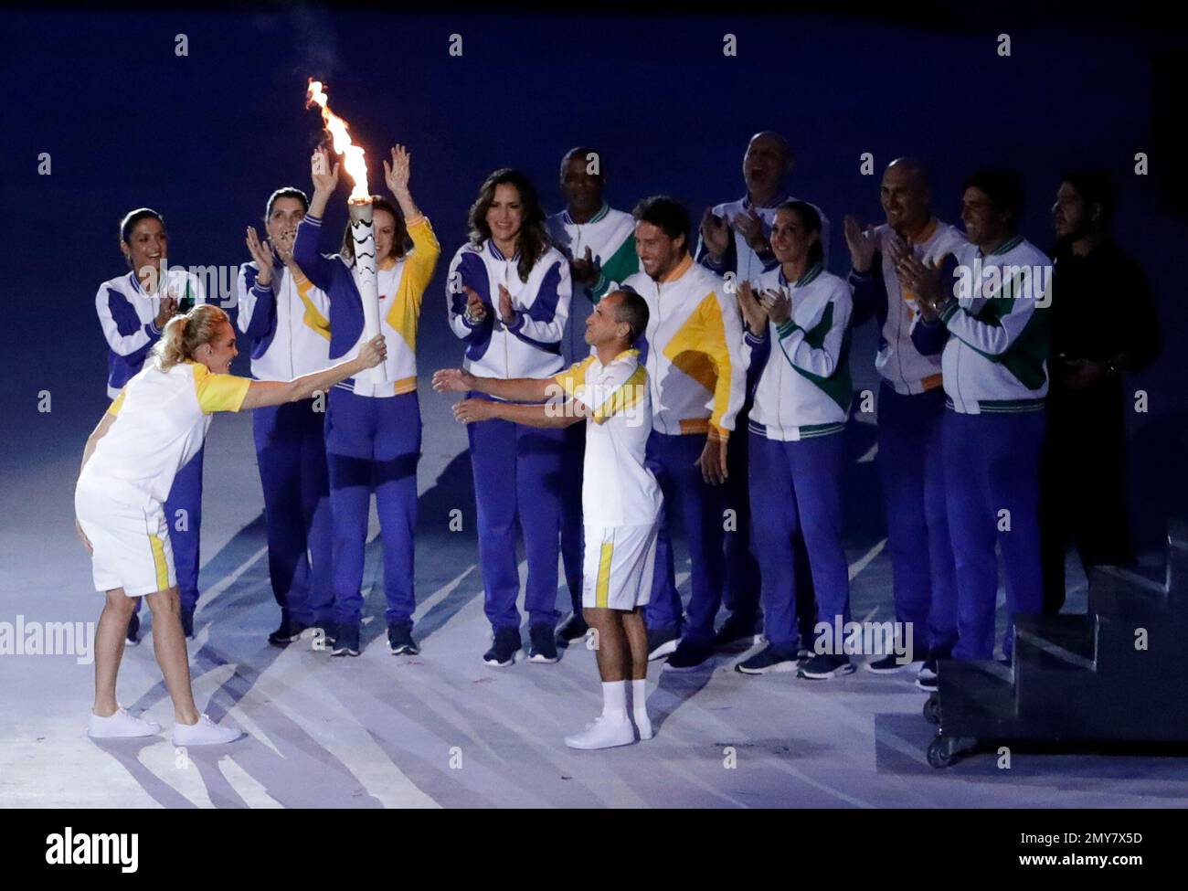 Brazilian marathon runner Vanderlei de Lima, center, is given the ...
