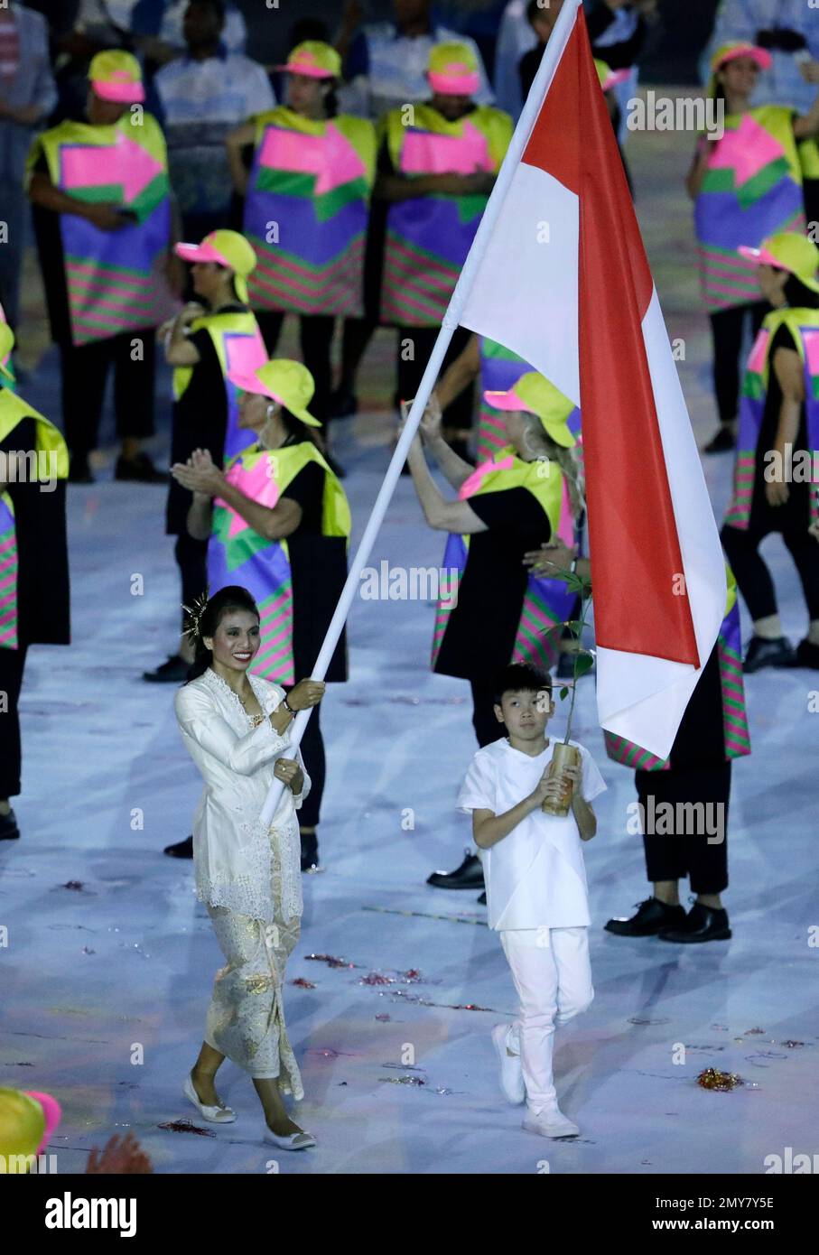 Maria Londa carries the flag of Indonesia during the opening ceremony ...