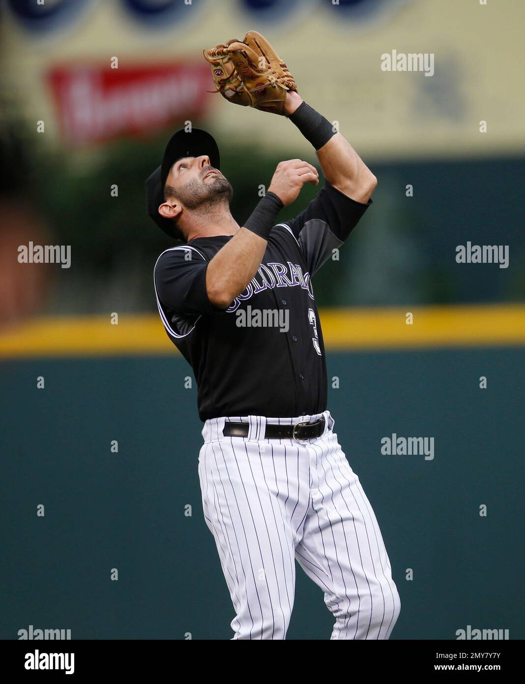 Colorado Rockies shortstop Daniel Descalso pulls in a pop fly off the ...