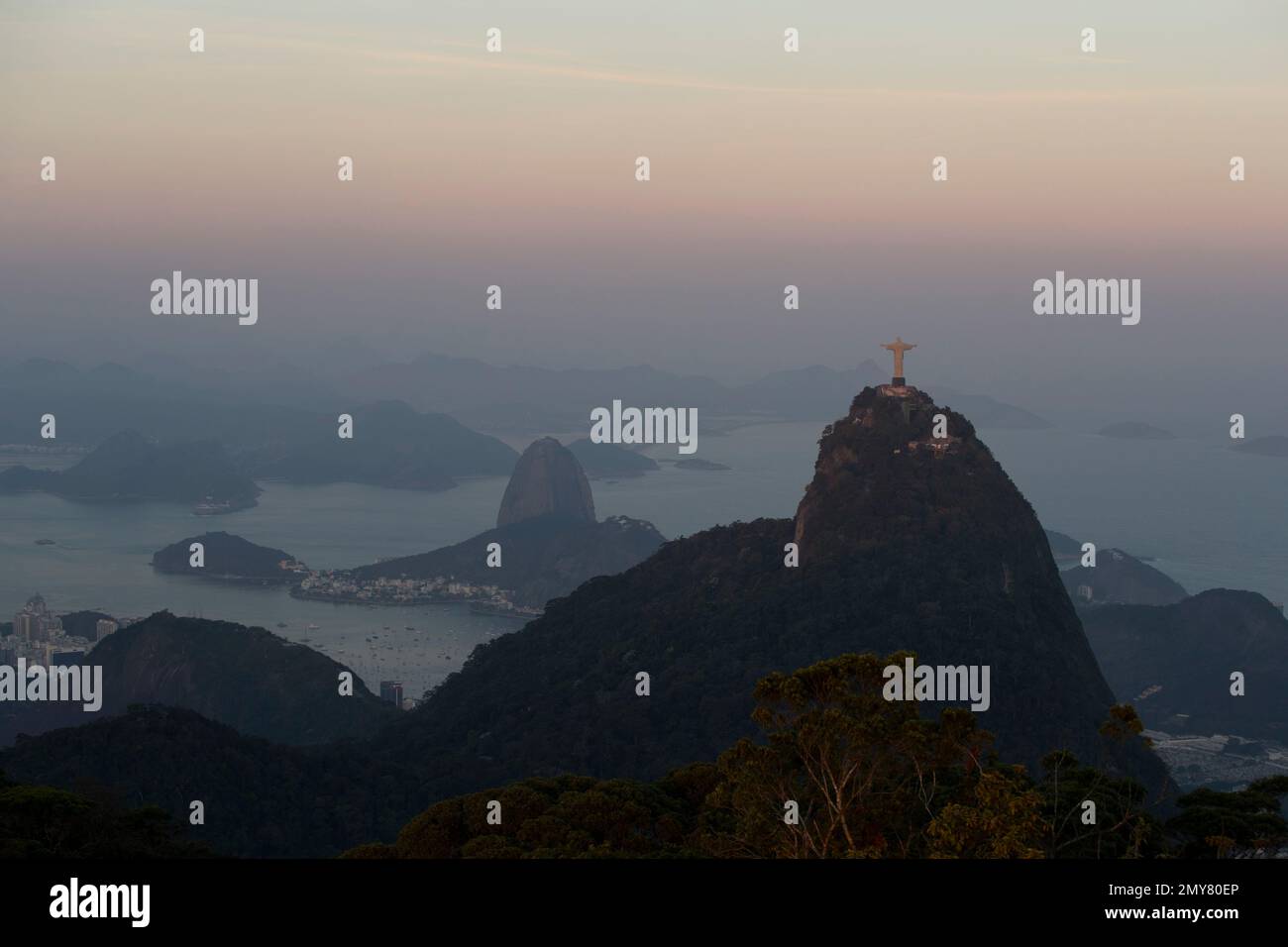 The Christ the Redeemer statue and Sugar Loaf mountain stand during ...