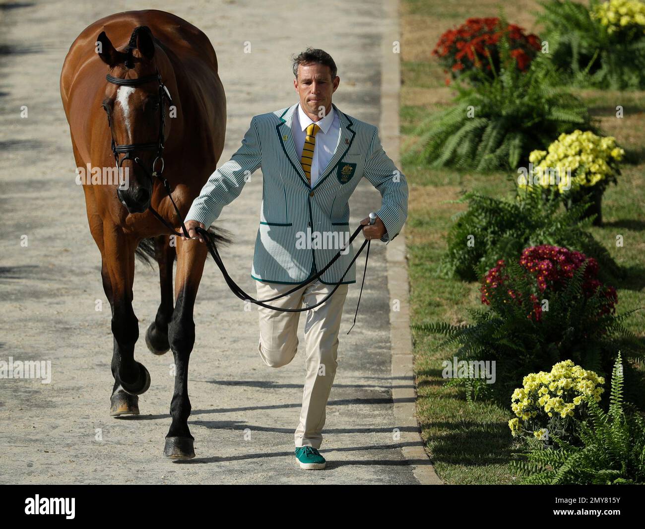 Australia's Sam Griffiths runs with horse Paulank Brockagh during a ...
