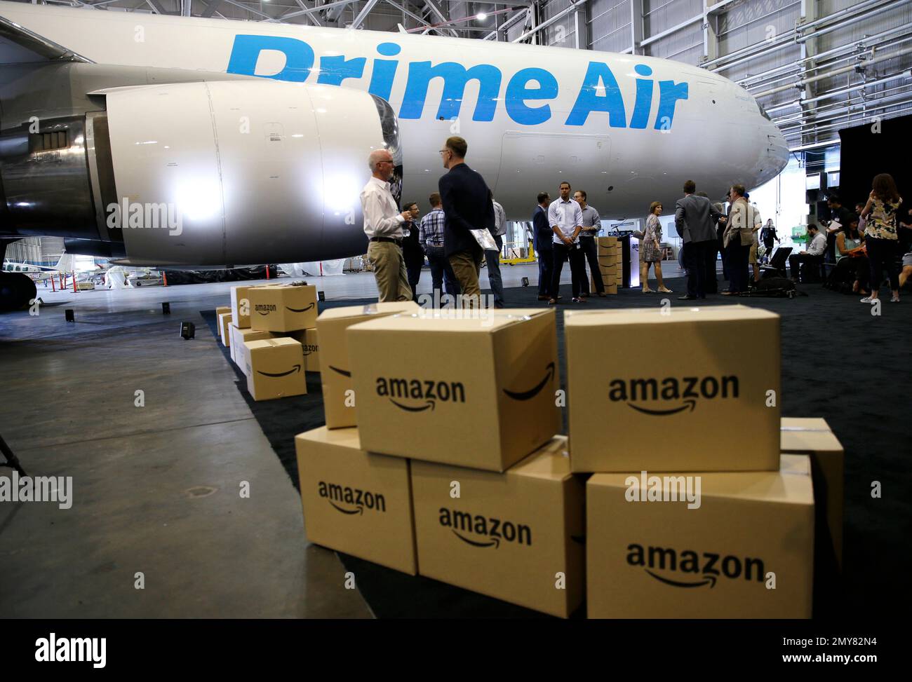 Amazon.com boxes are shown stacked near a Boeing 767 Amazon "Prime Air ...