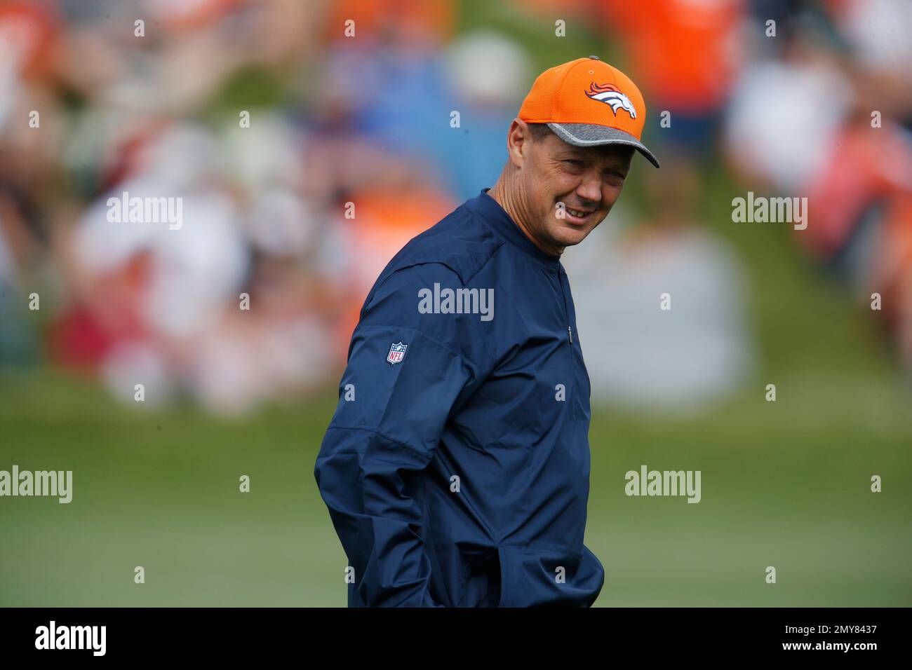 Denver Broncos offensive coordinator Rick Dennison takes part in drills ...