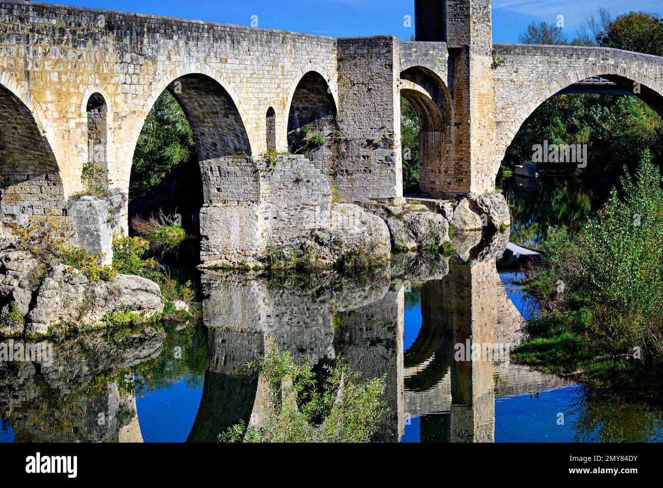 Famous medieval bridge over the river Fluvia in the medieval village de ...
