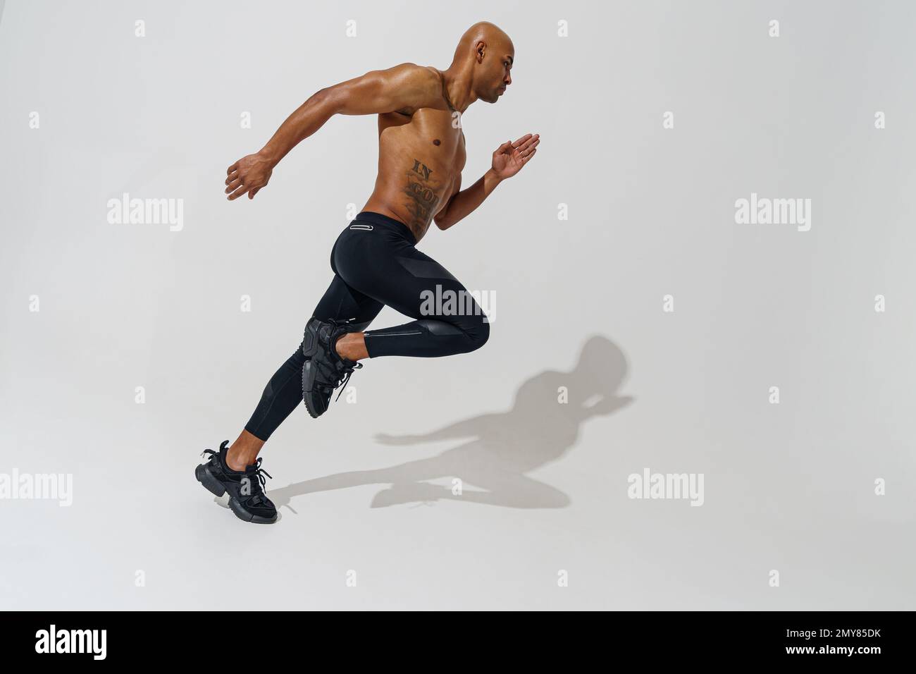Professional male athlete running isolated on white studio background ...
