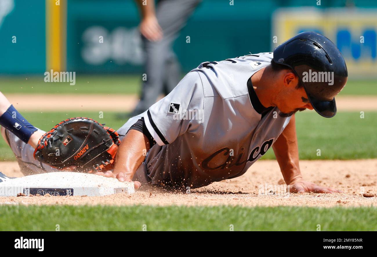 Chicago White Sox's Tyler Saladino dives back into first base ahead of ...
