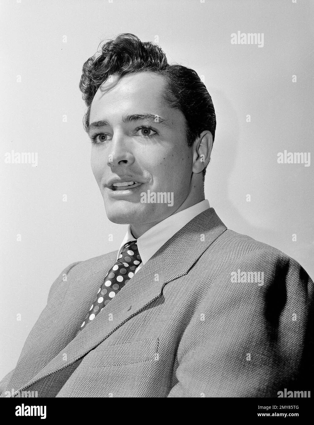 Actor John Derek, who believes one should marry young, is shown in New ...