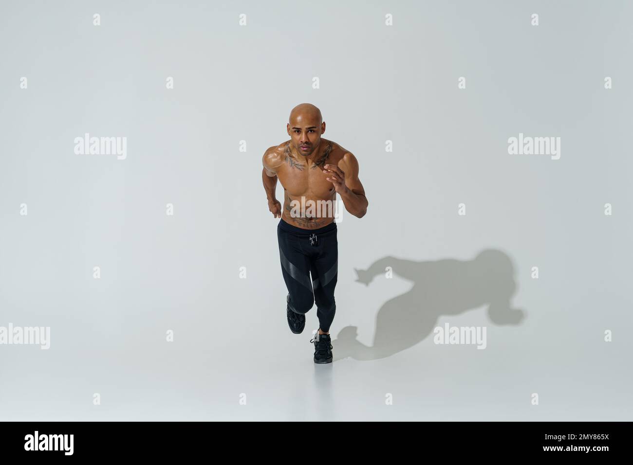 Top view of Professional male athlete running isolated on white studio ...