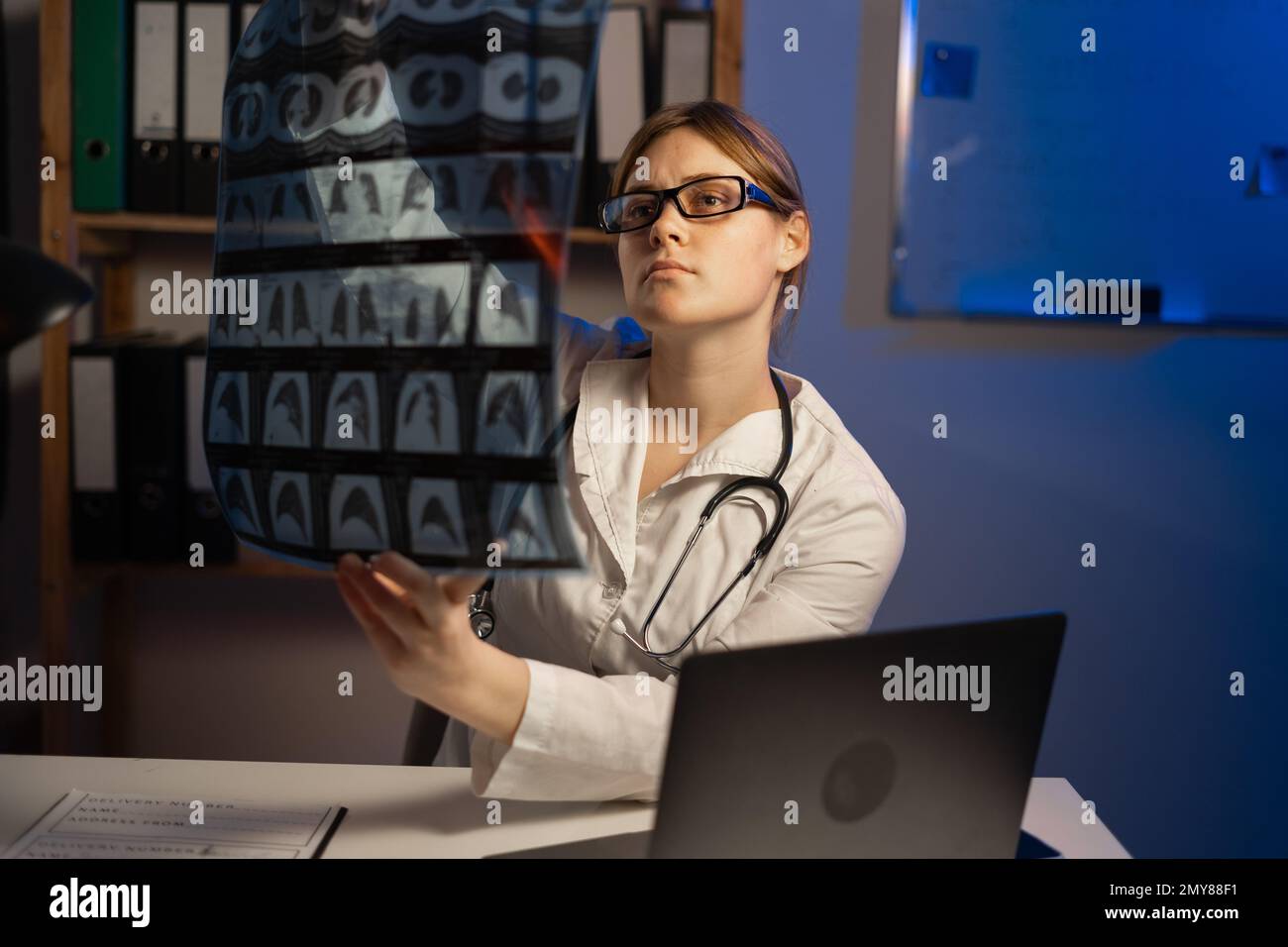 Doctor examine MRI picture in the office at night. Medical diagnosis on ...