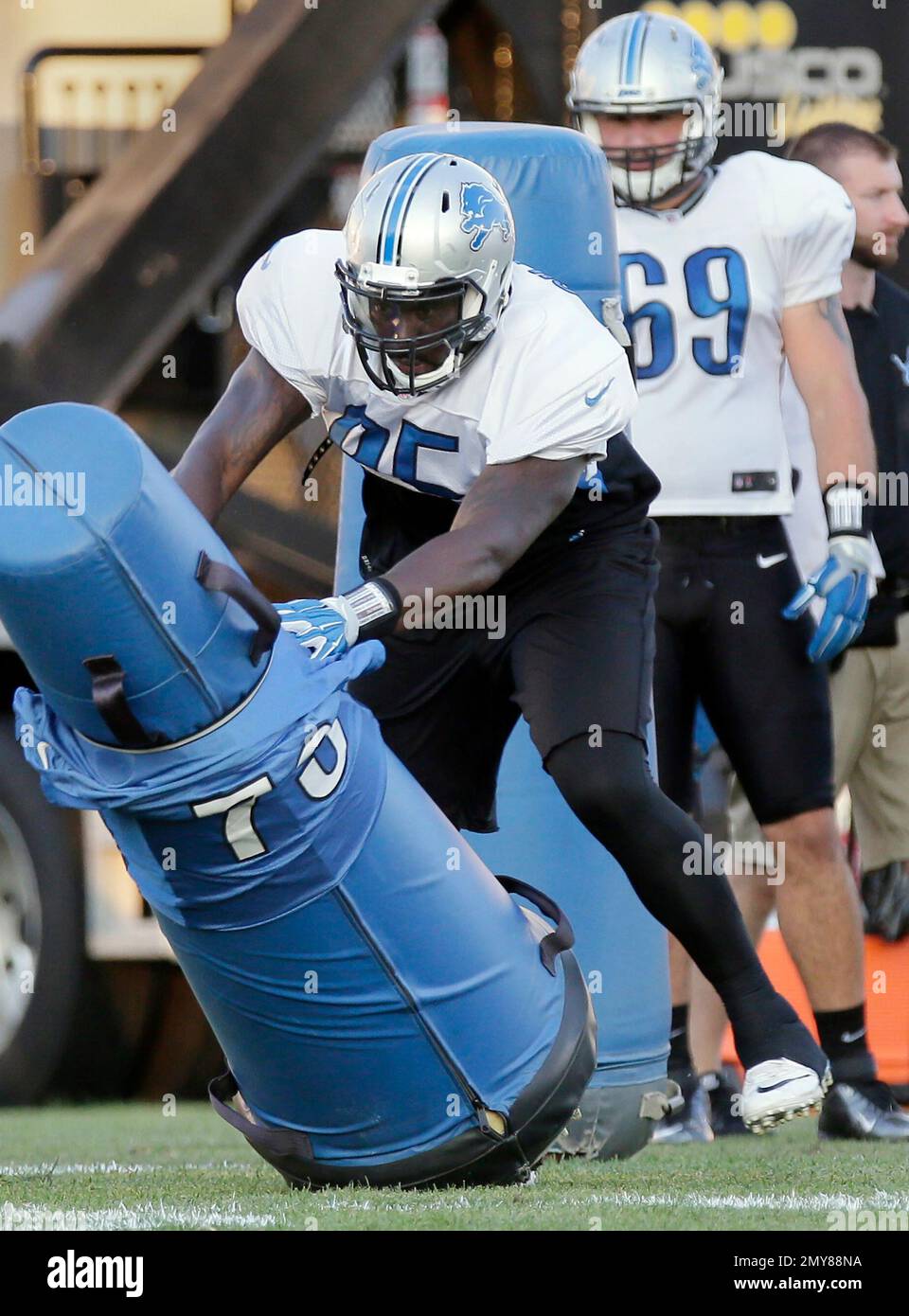 Detroit Lions defensive end Wallace Gilberry (95) hits a tackling dummy ...