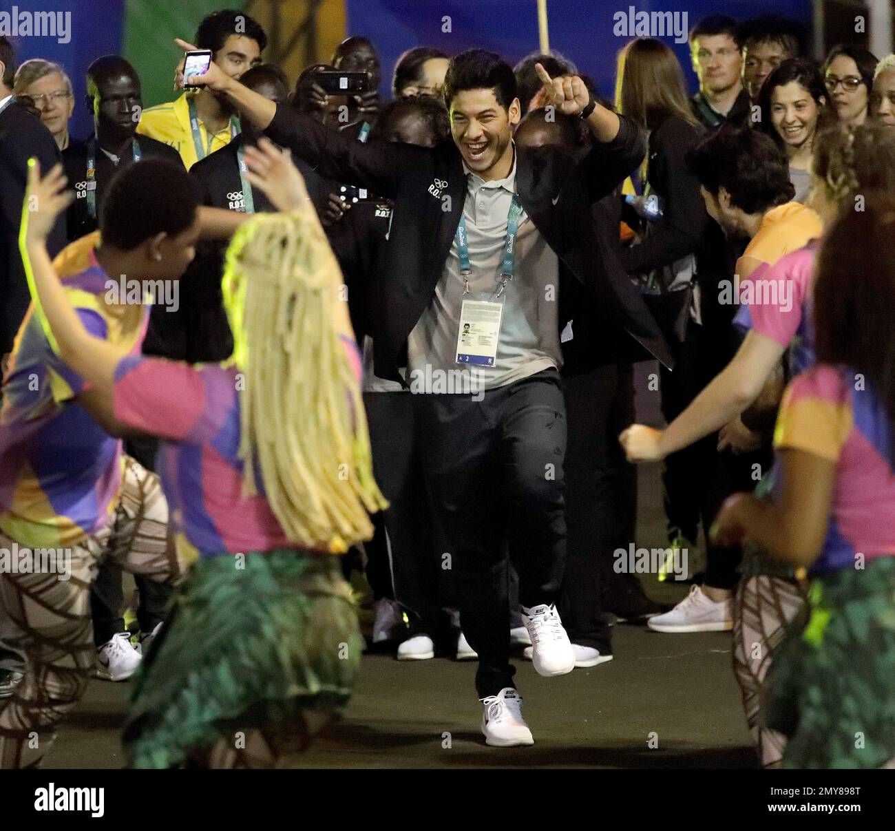 Refugee Olympic Team swimmer Rami Anis dances with performers during a ...