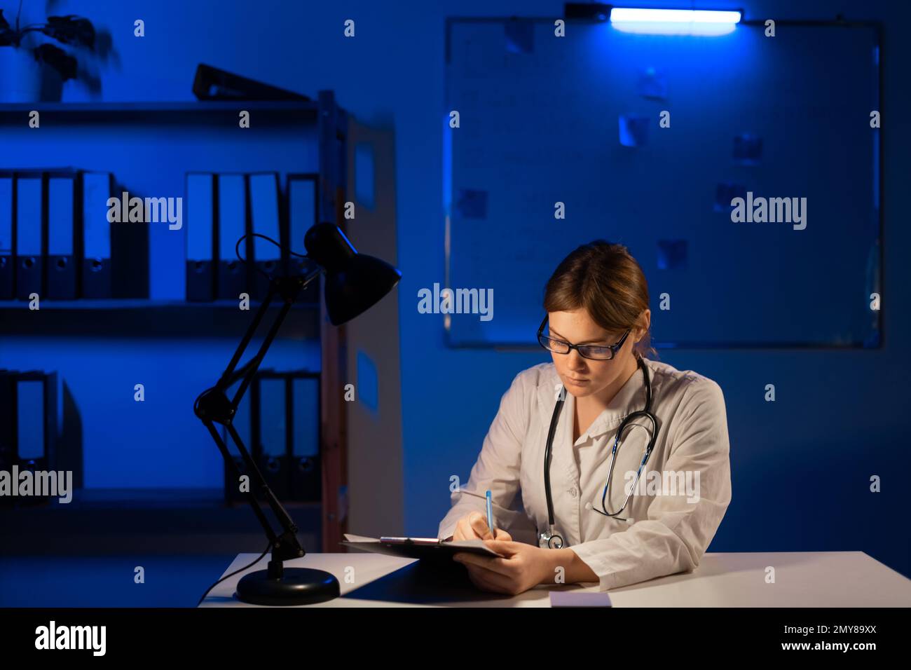 Doctor analyzes medical report. Thorough physical examination, patient ... Doctor analyzes medical report. Thorough physical examination, patient ...