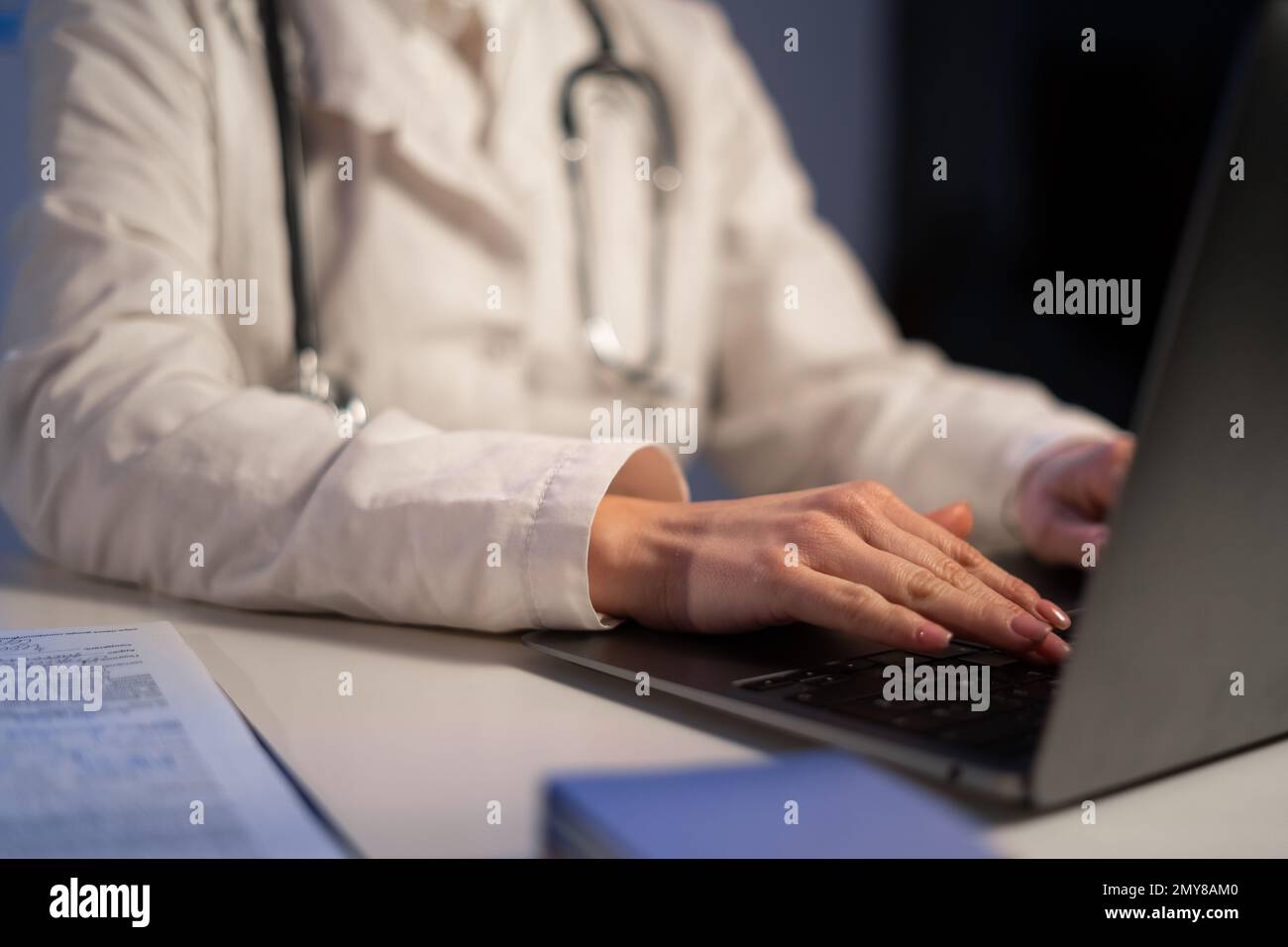 Close up of doctor or nurse hands concentrate working on laptop ...