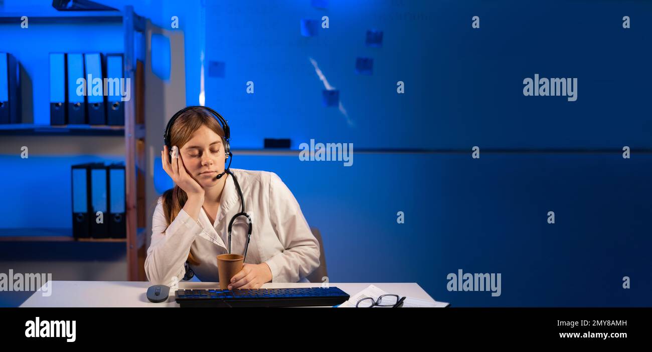 Tired female doctor sitting table hi-res stock photography and images ...