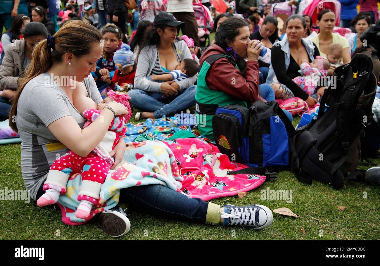 Mothers feed their babies during the event, "Breastfeeding is an act of ...