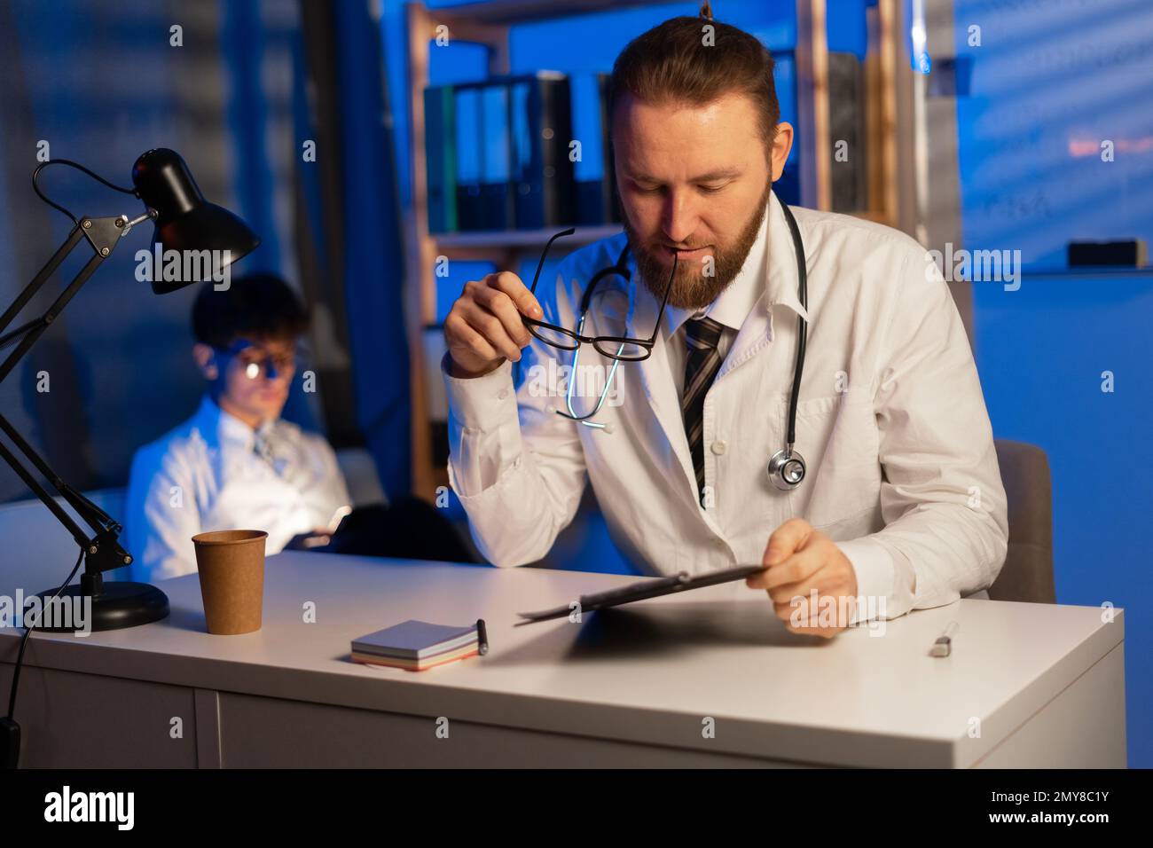 Adult and young doctors working during shift night. Medicine and ...