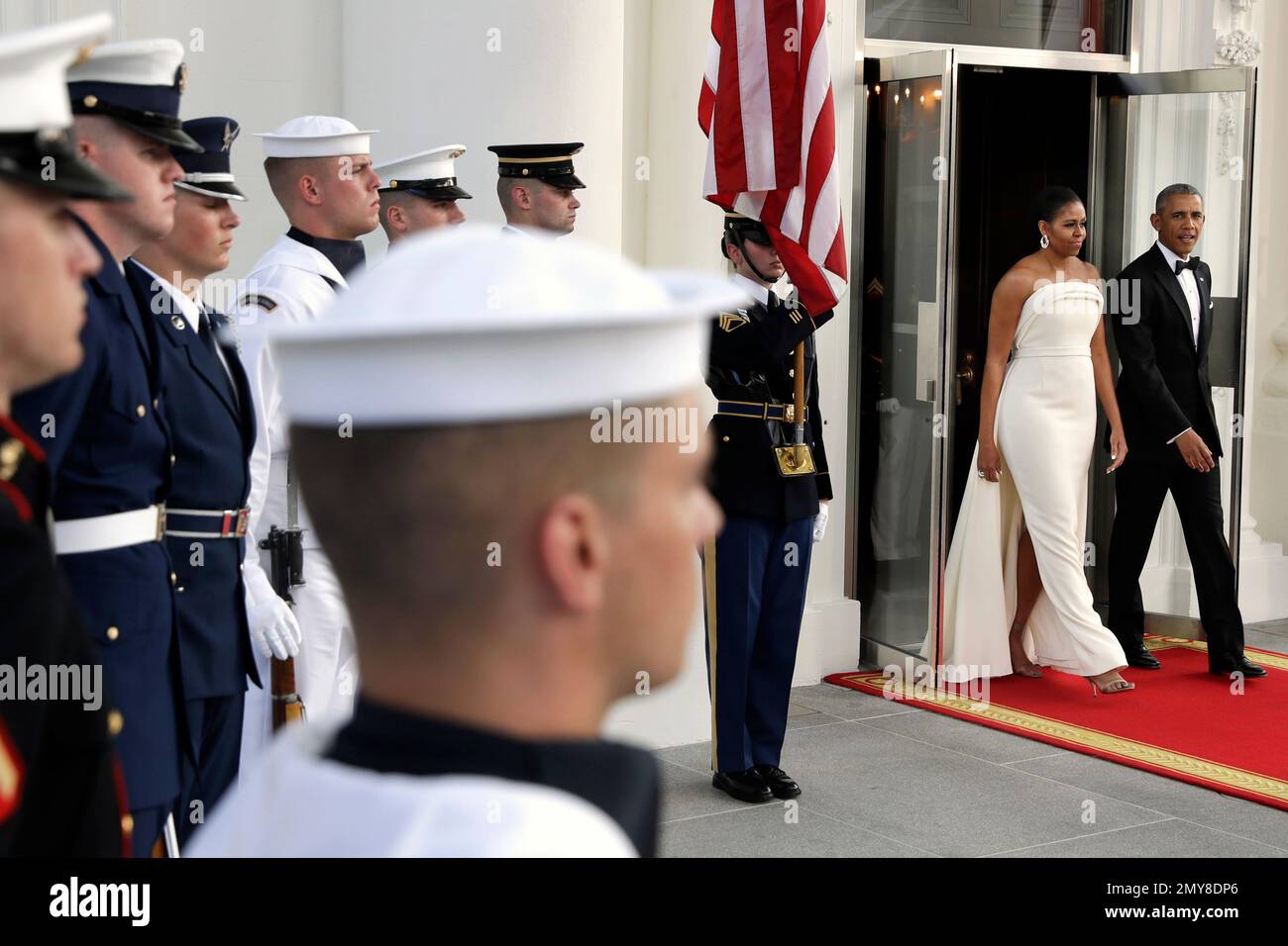 President Barack Obama, right, with first lady Michelle Obama, walk ...