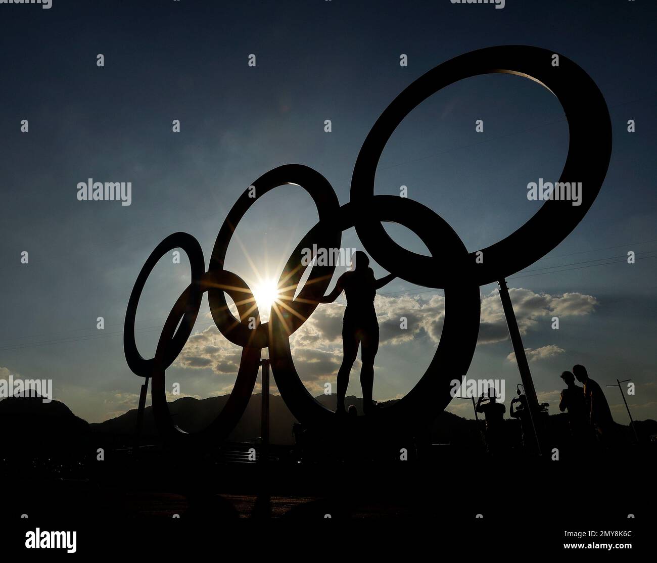 A woman poses for a photo with the Olympic Rings at the Olympic Park in ...