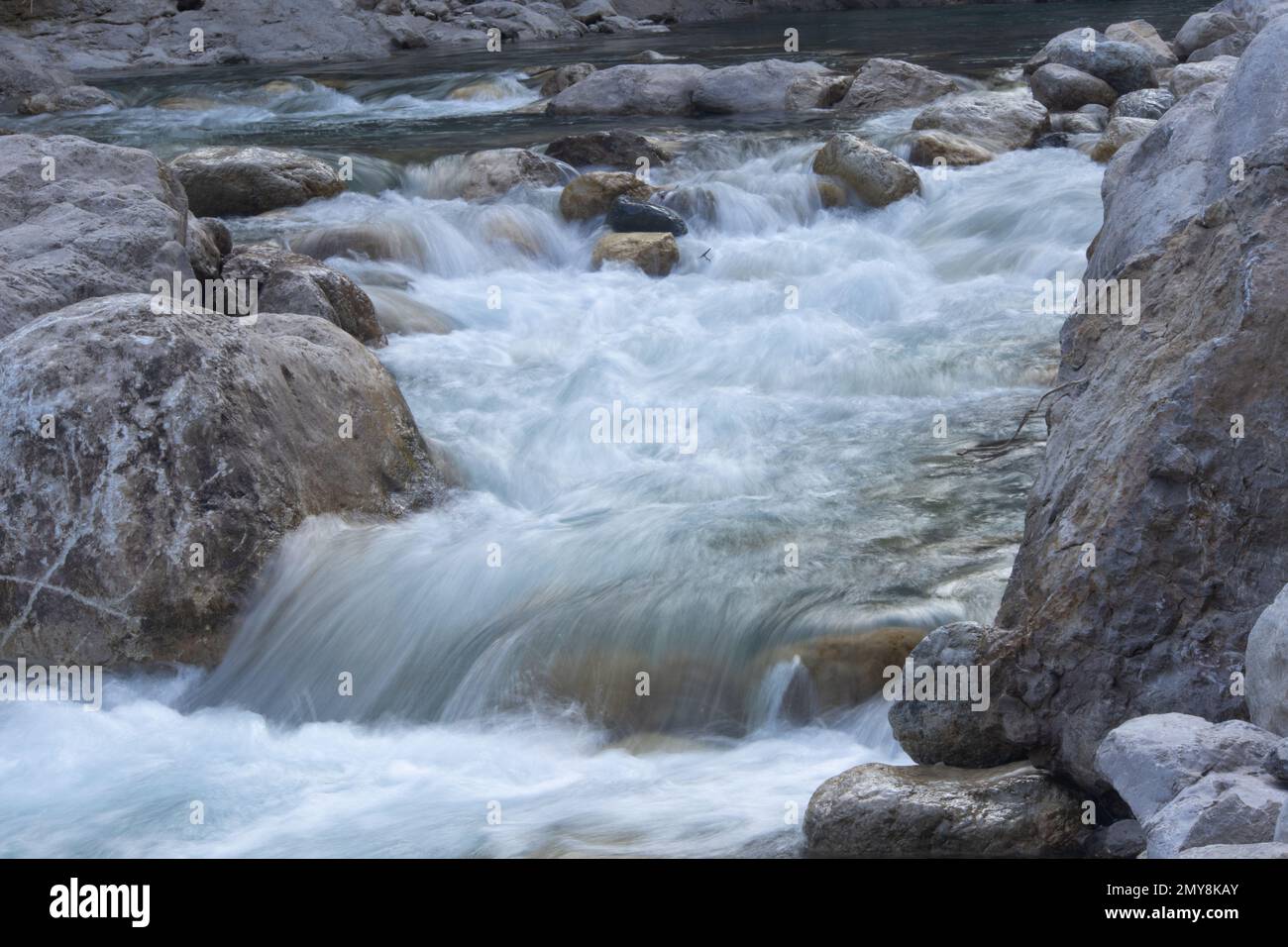 Mountain stream of water among rocks and stones Stock Photo - Alamy
