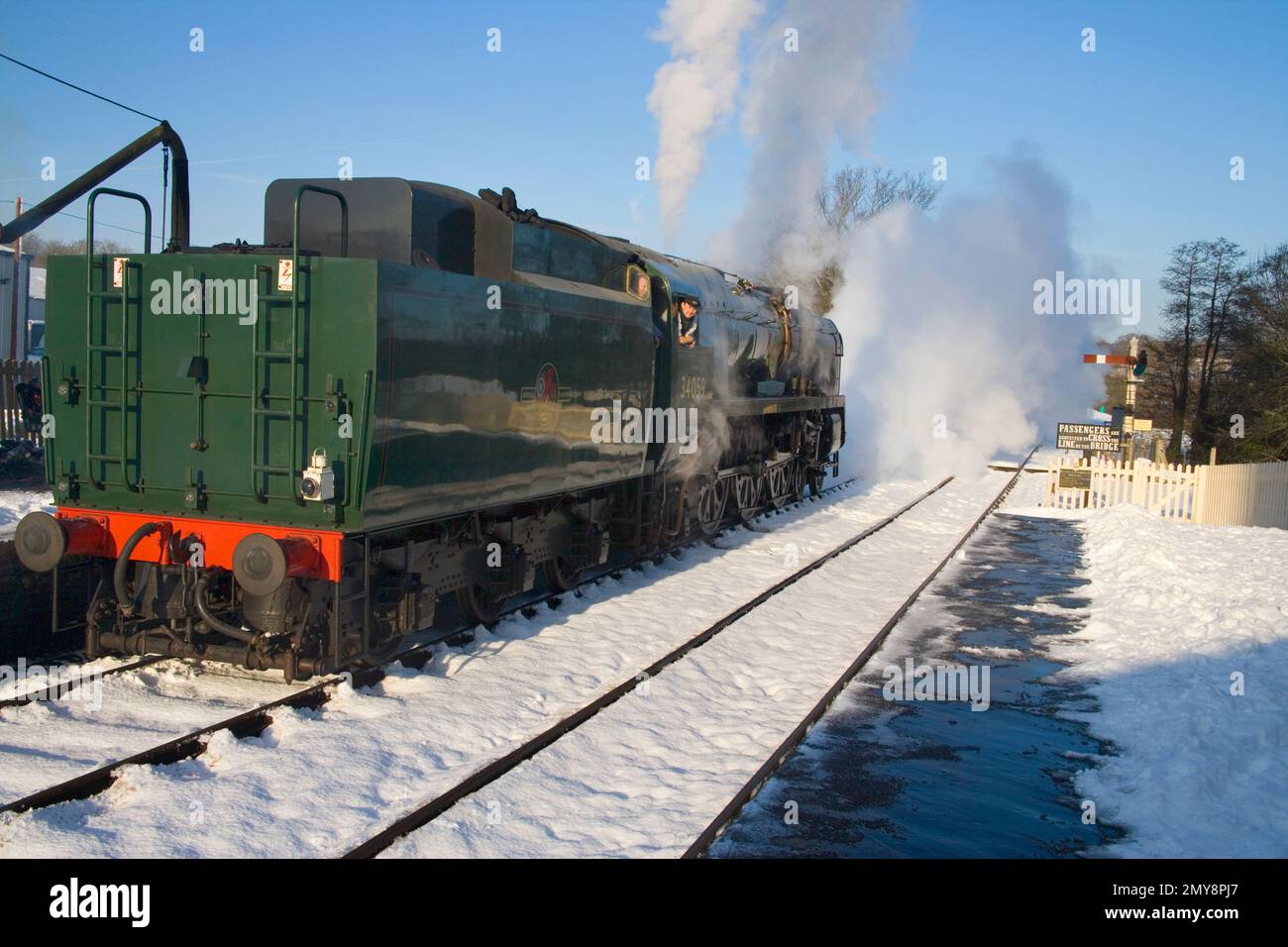 steam train and snow in winter on the bluebell railway in East Sussex ...