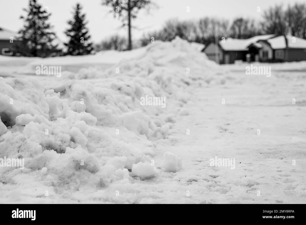 Snowbank at the end of a driveway left after city snowplows cleared a ...