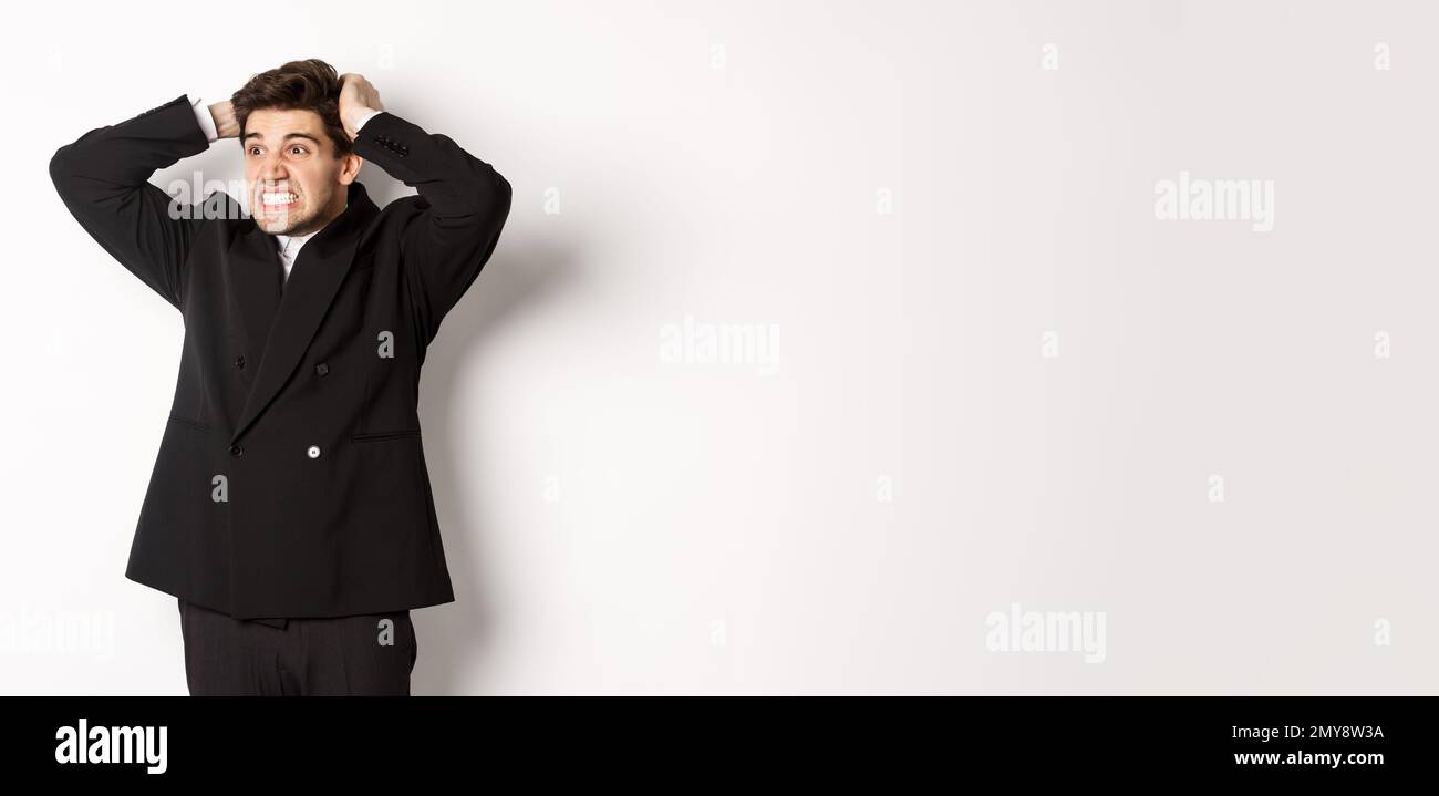 Image of frustrated and angry businessman in black suit, ripping hair ...