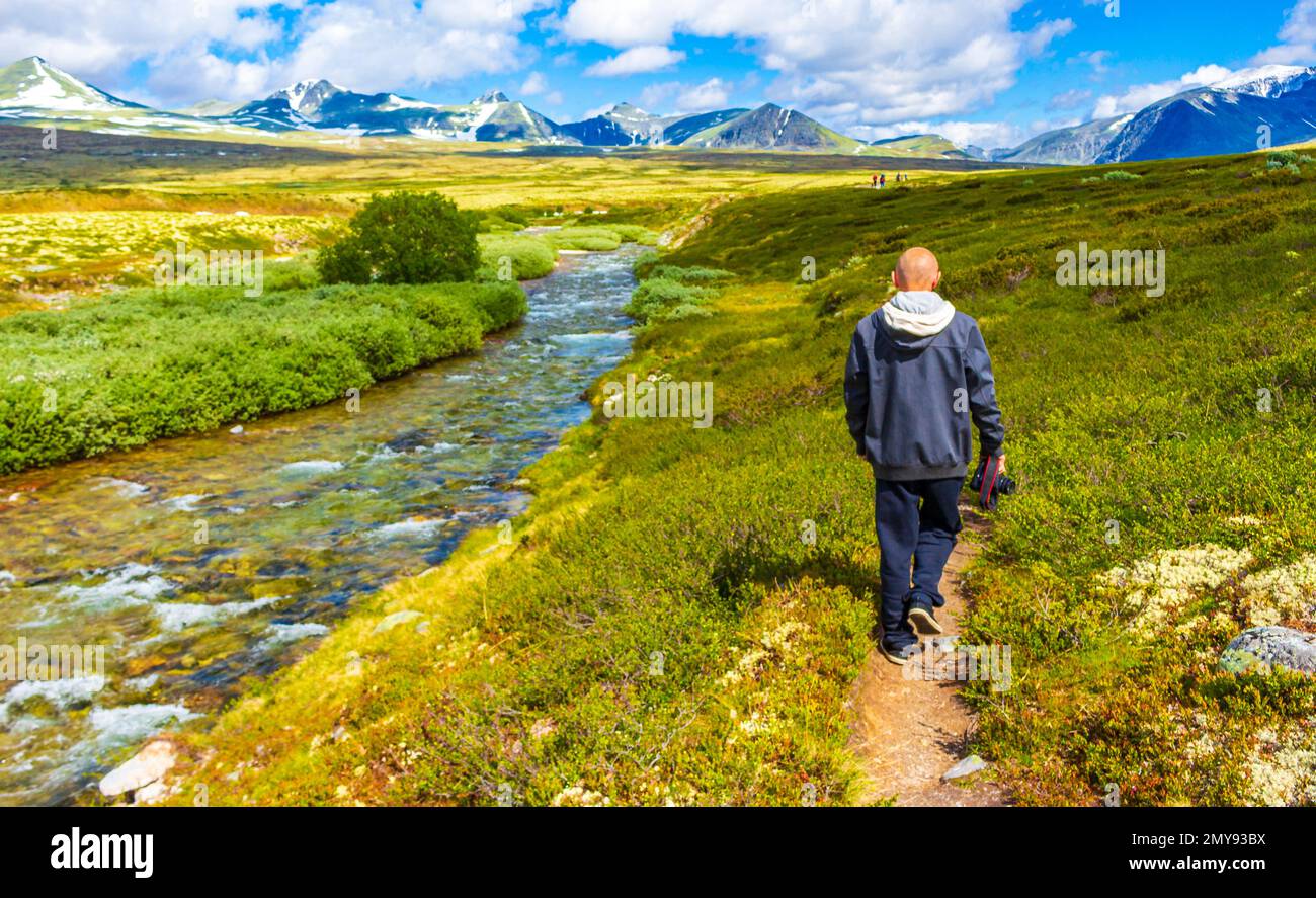 Young hiker traveler photographer with camera and beautiful summer ...