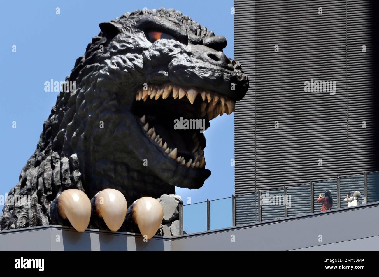 People take a picture of Godzilla's head at Shinjyuku Toho Building at ...