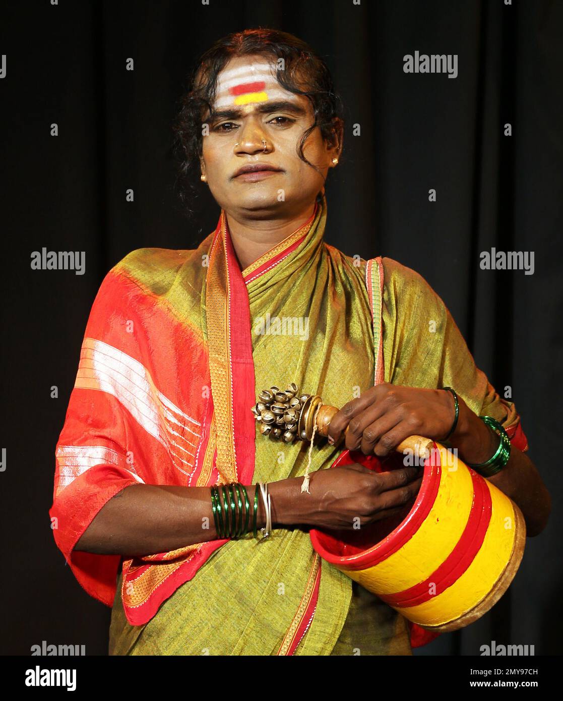 An Indian transgender Bhagyamma Jogathi holds a traditional musical ...