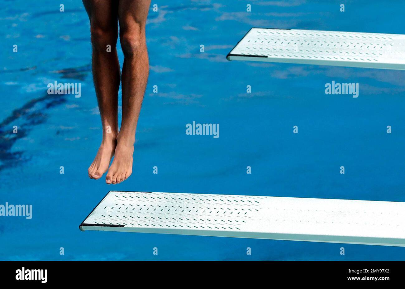 A member of the Australian diving team leaps on a diving board during a ...