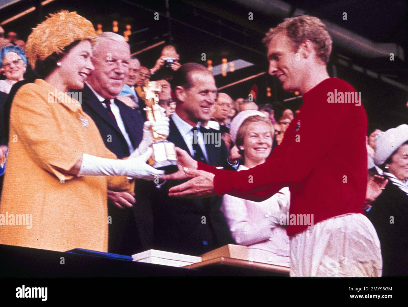 FILE - In this July 30, 1966 file photo Queen Elizabeth II presents the ...