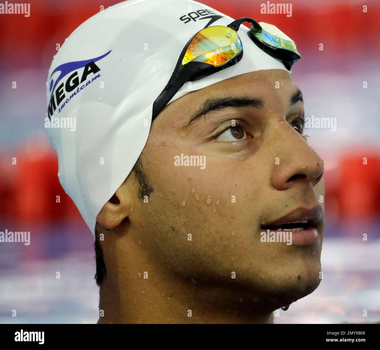 Olympic refugee team member Rami Anis talks with his coach as he swims ...