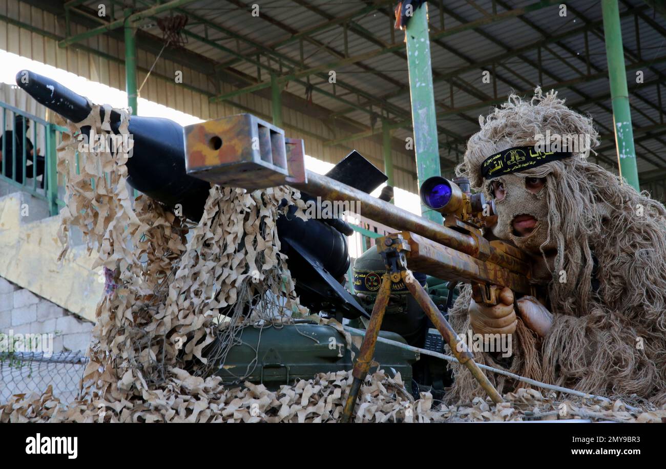 A Palestinian masked member of Al-Quds Brigades, the military wing of ...