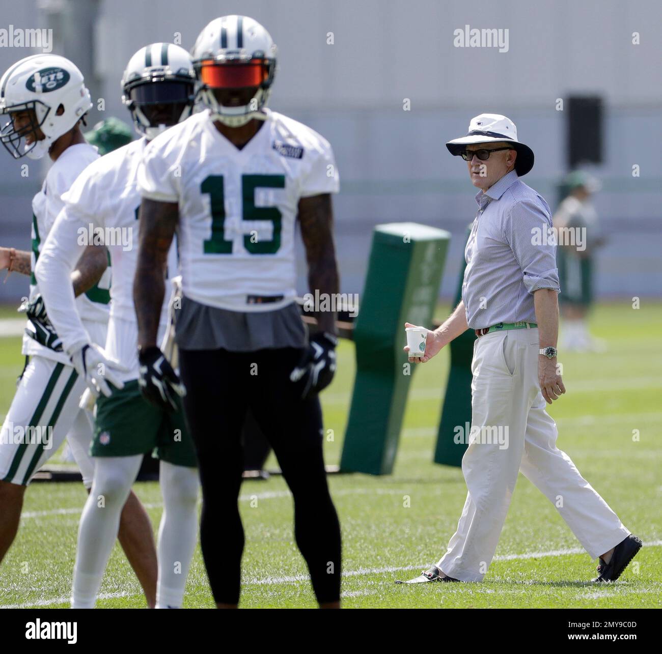New York Jets owner Woody Johnson, right, looks on as wide receiver Brandon Marshall (15) and ...