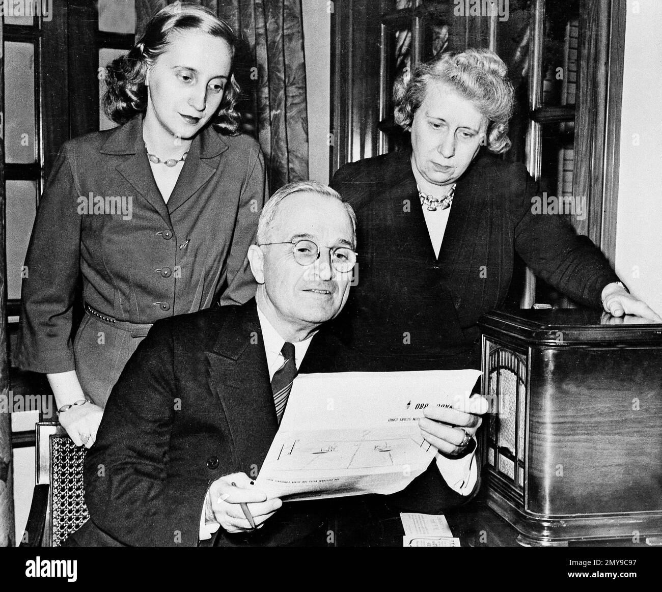 Margaret Truman, left, and her mother Bess look over the shoulder of ...